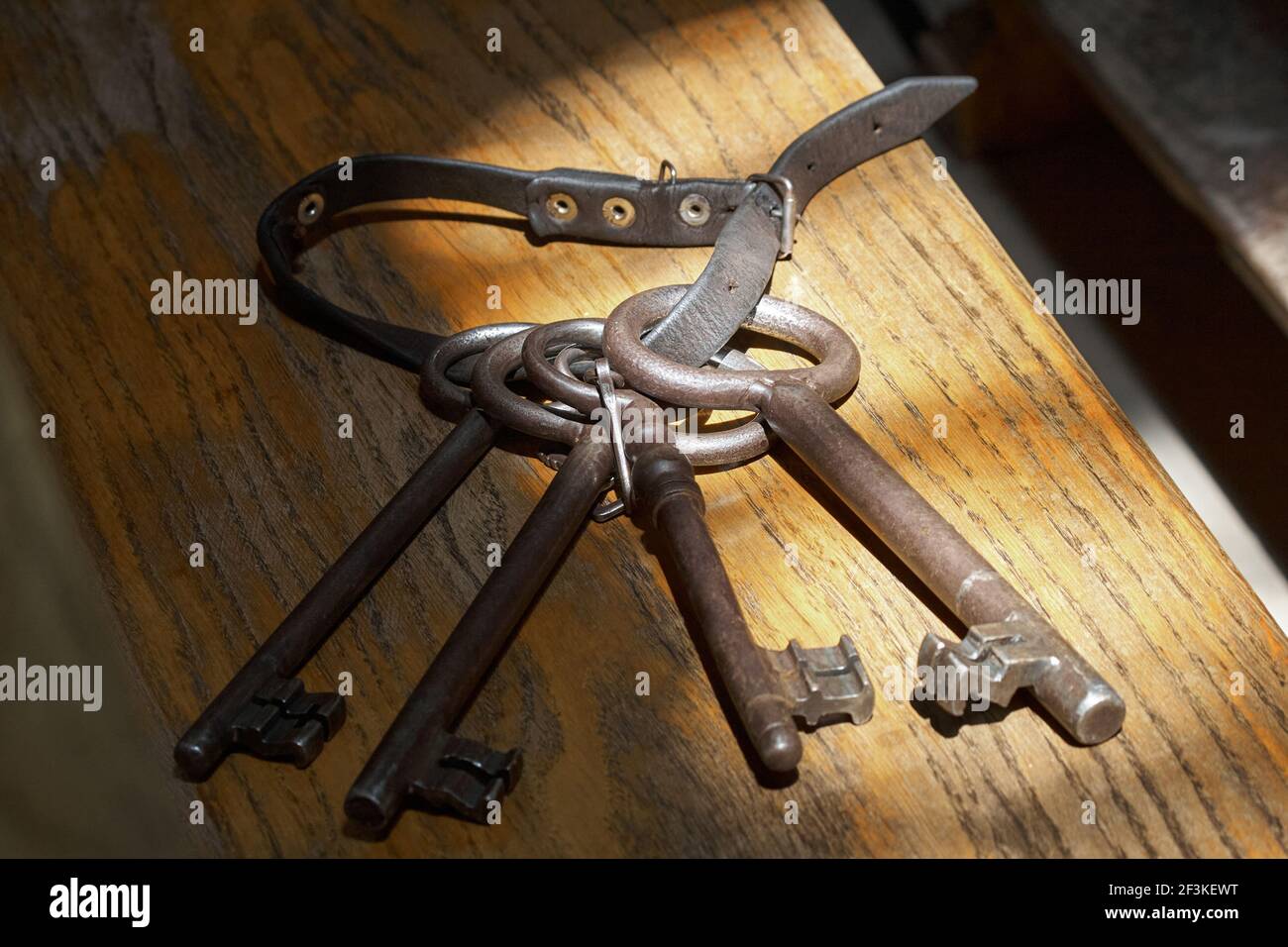 A bunch of antique iron keys on old wooden background in the sun Stock ...