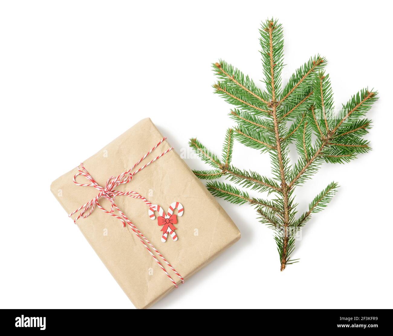 box wrapped in brown kraft paper and tied with rope, gift on white ...