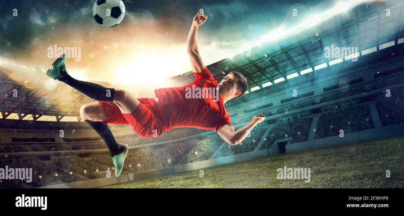 Male football or soccer player at stadium in flashlight. Young male ...
