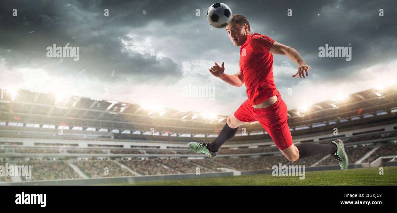 Male football or soccer player at stadium in flashlight. Young male ...