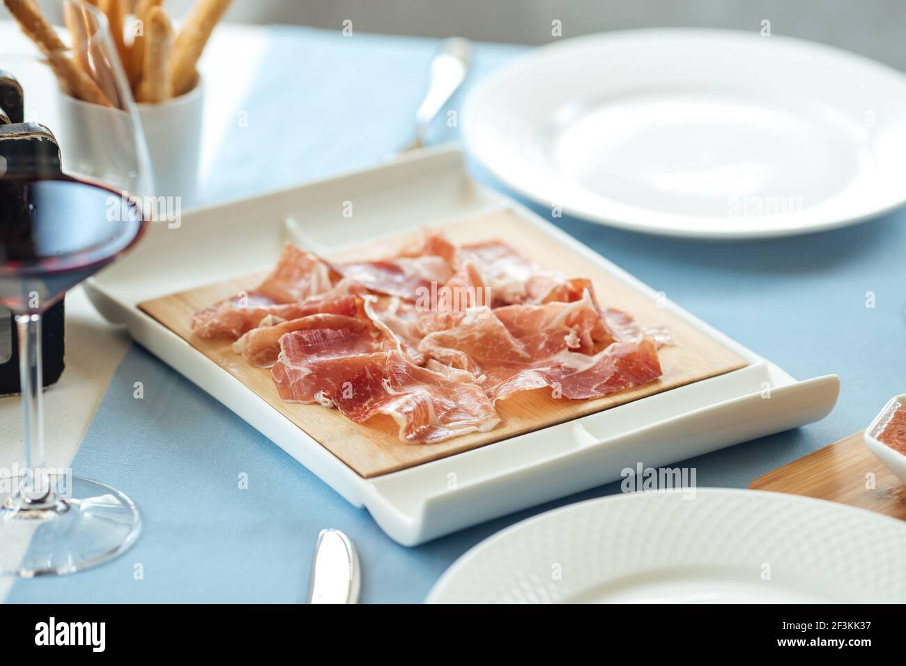 Sliced jamon meat on the restaurant table Stock Photo - Alamy