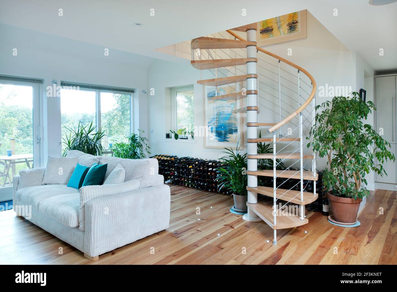 Main living area and spiral staircase Stock Photo - Alamy