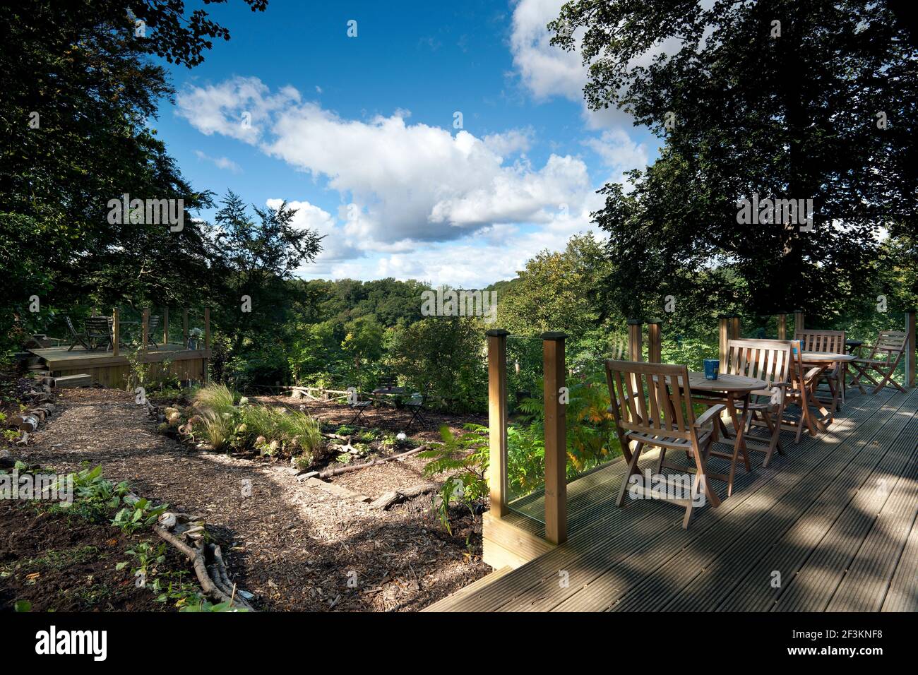 Exterior, looking from the deck to the garden and the raised seating ...