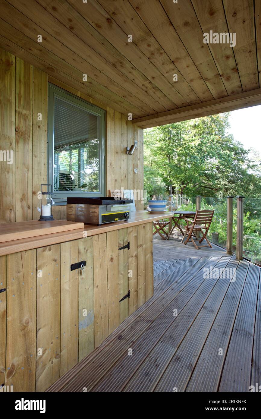 Exterior, the outside cooking area on the covered deck Stock Photo - Alamy