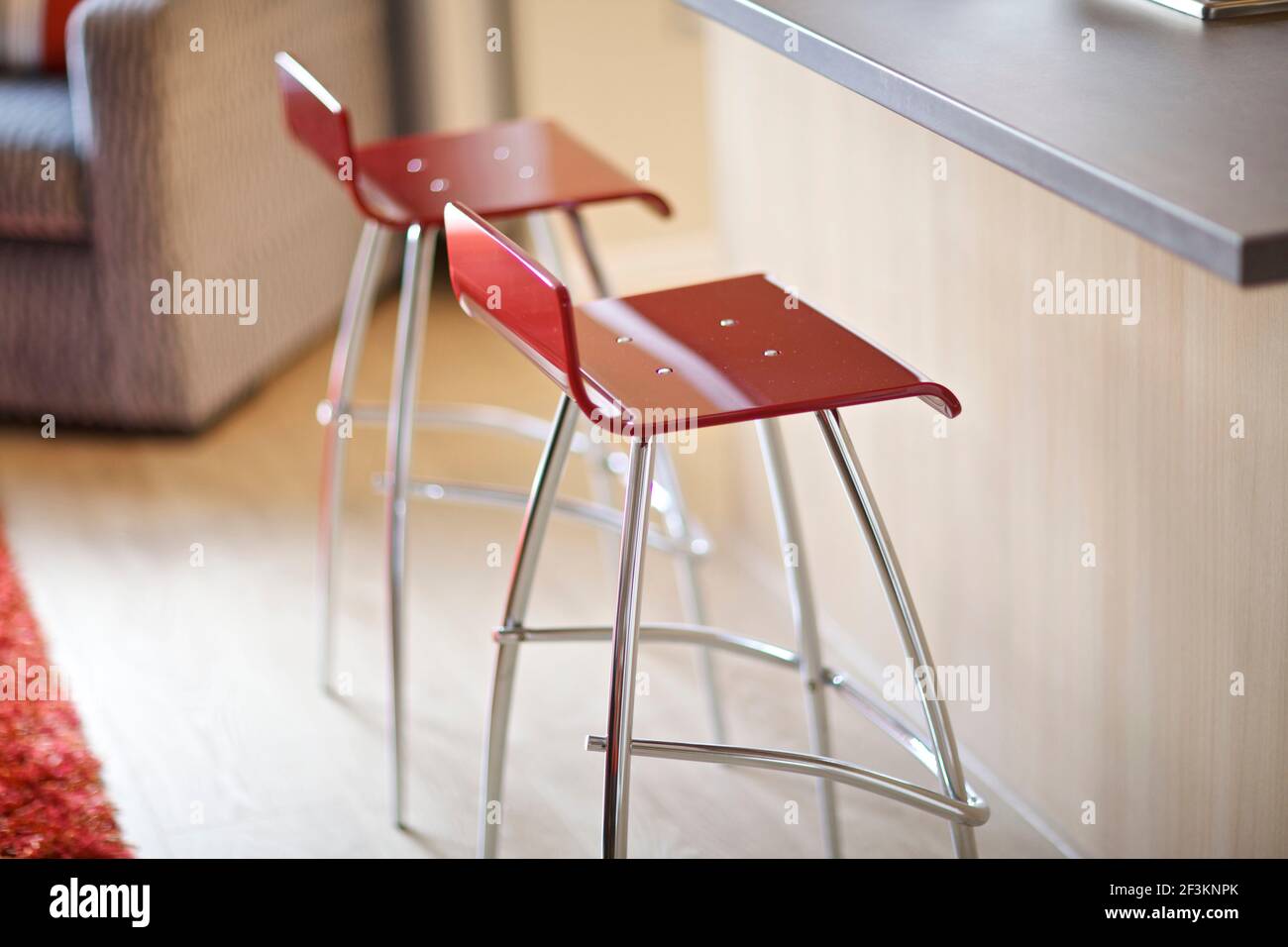 Two red chairs at breakfast bar Stock Photo - Alamy