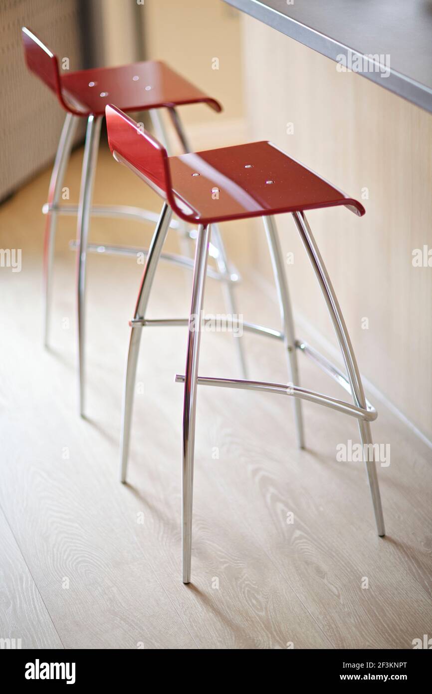 Two red chairs at breakfast bar Stock Photo - Alamy