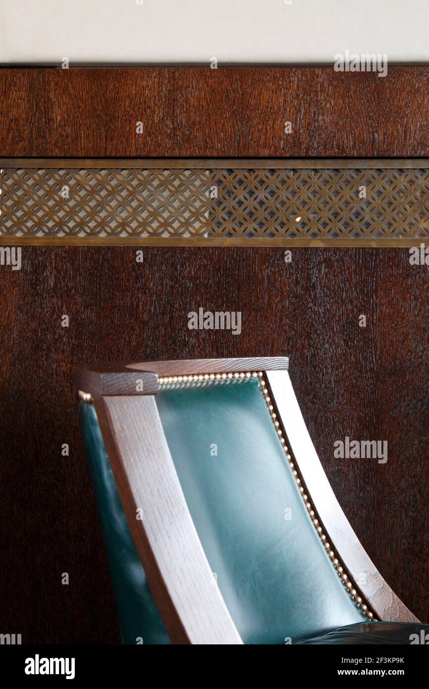 Detail of green leather chair, with dark wood frame and brass ...