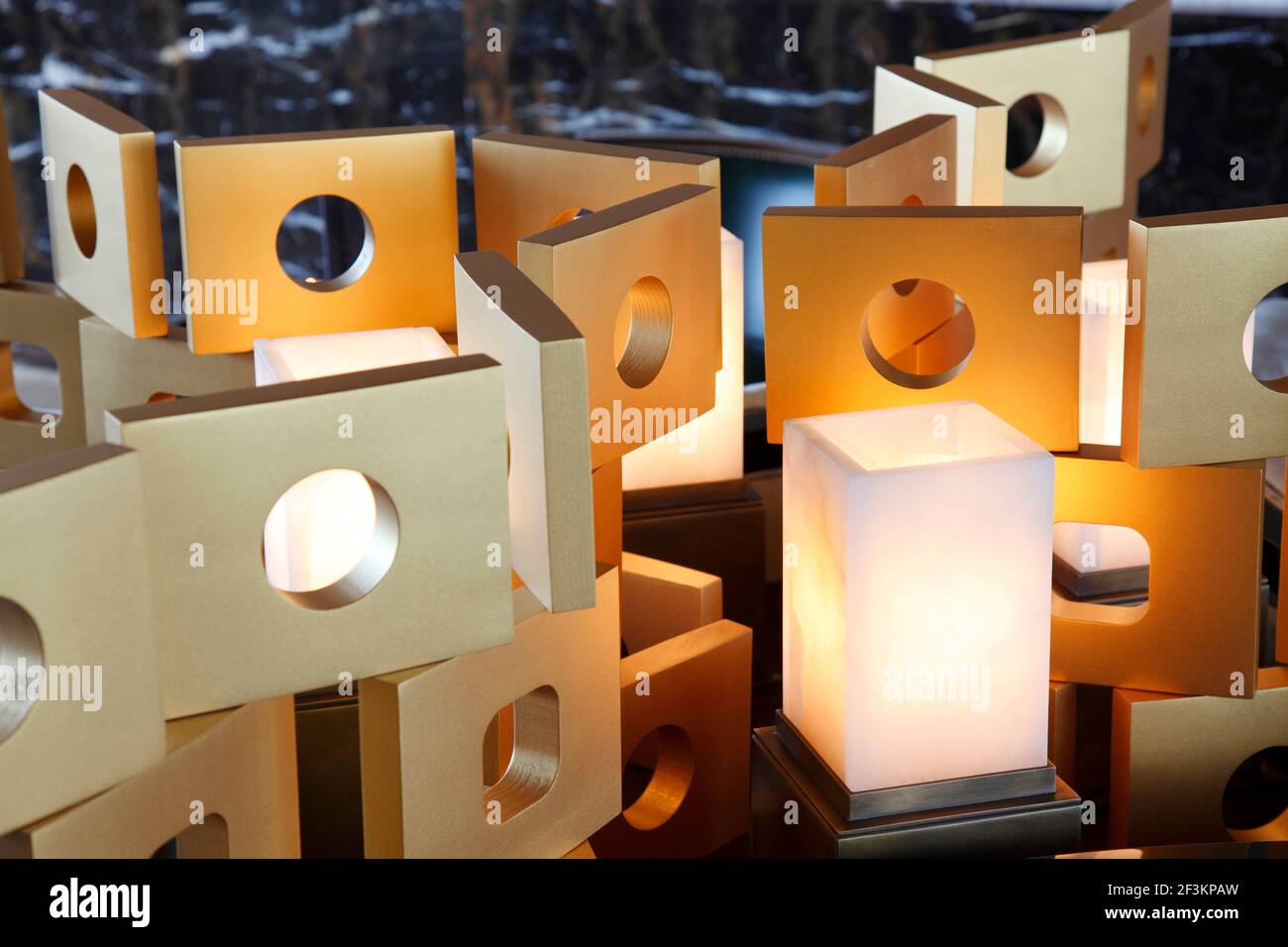 Sculptural centrepiece made from angled gold spray painted mdf lit by ...