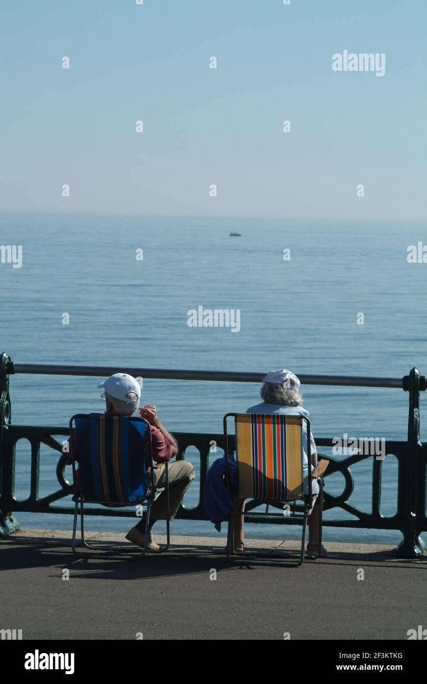 People enjoying the sun and the sea view at Hove, East Sussex, England ...