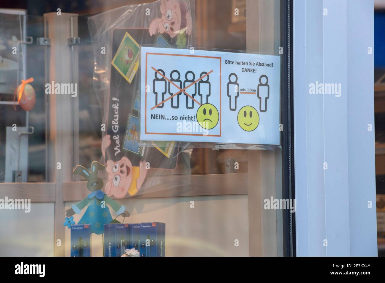 Sign "Please keep your distance" in the shop window of a retail store ...