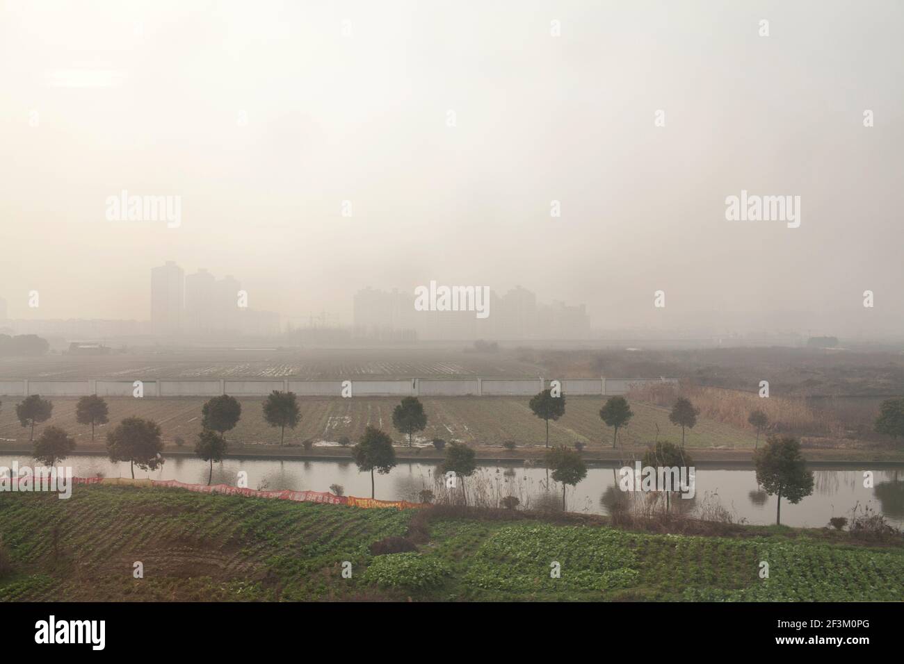 Building construction obscured by fog and smog in the rural outskirts ...