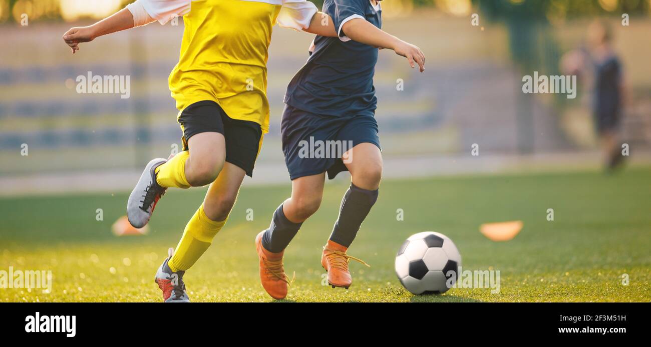 Two Soccer Players in a Duel on Grass Venue. Boys Running After Black ...