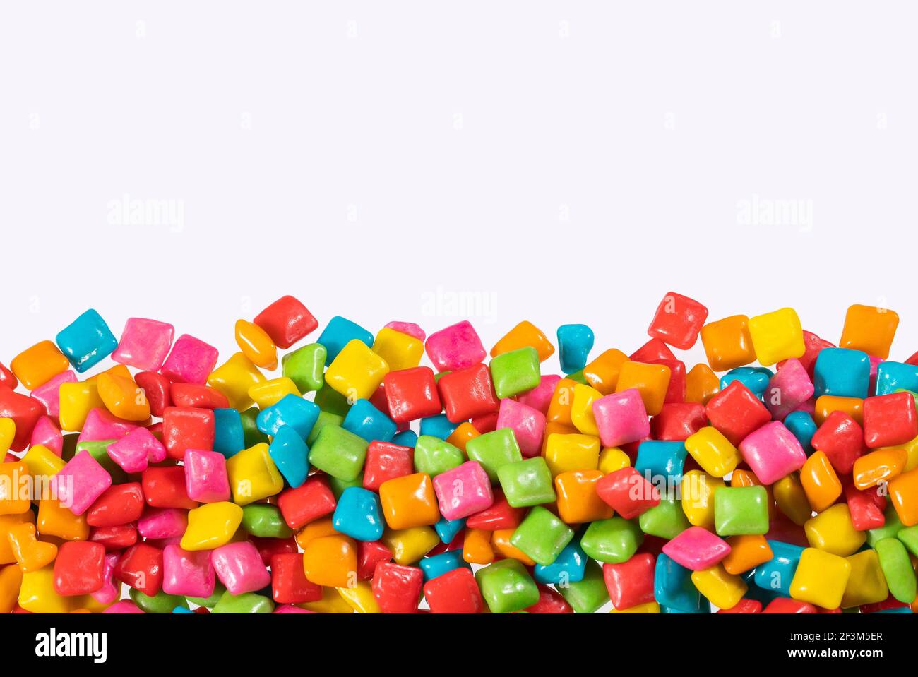 Mini colored gum in heap - White background Stock Photo - Alamy