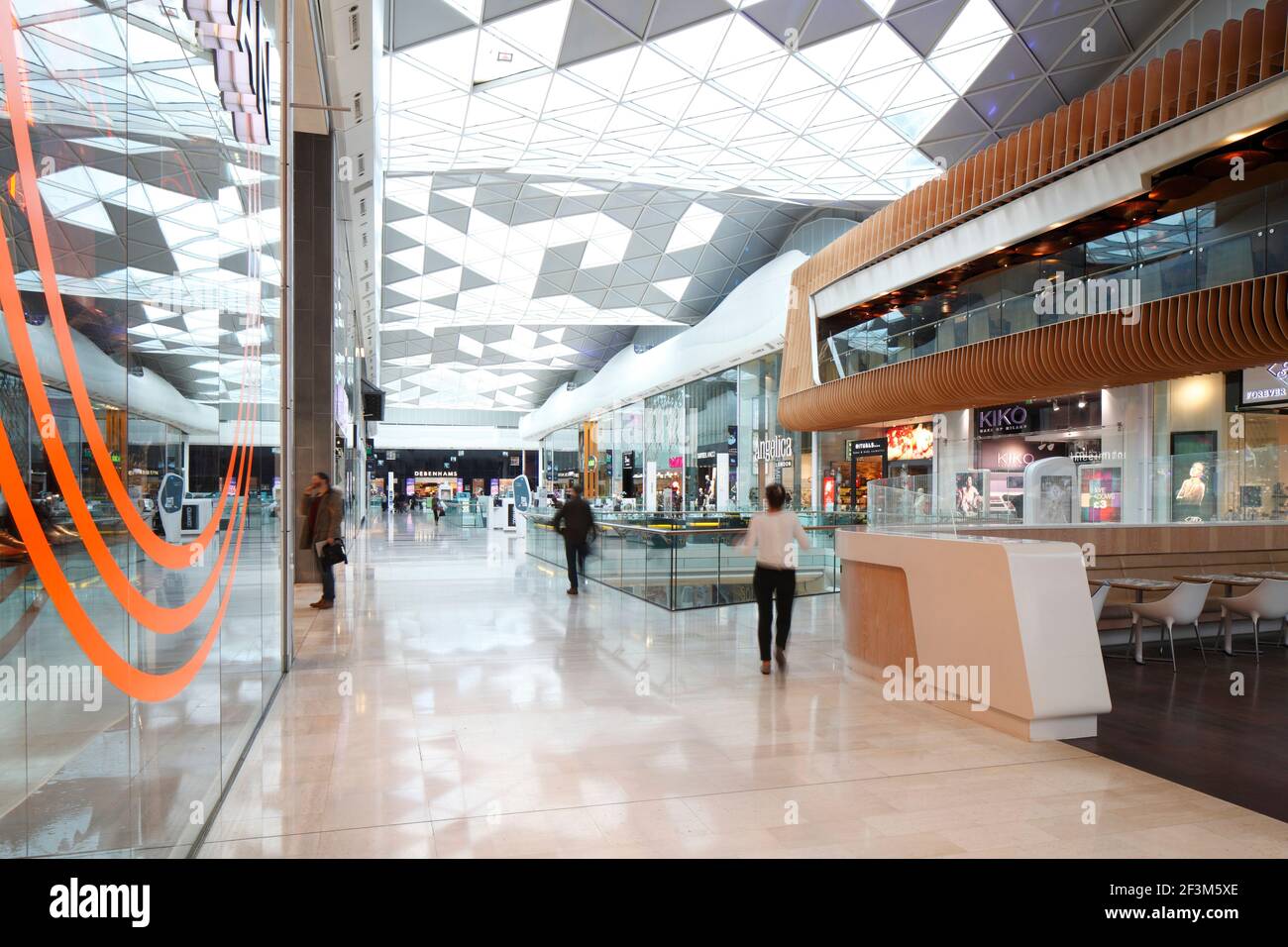View along mall interior with timber clad restaurant on right beneath ...