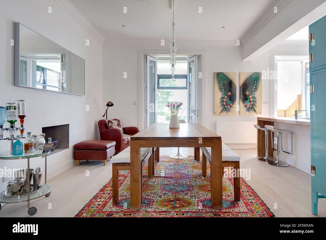 Open plan dining room with patterned rug in UK home Stock Photo - Alamy