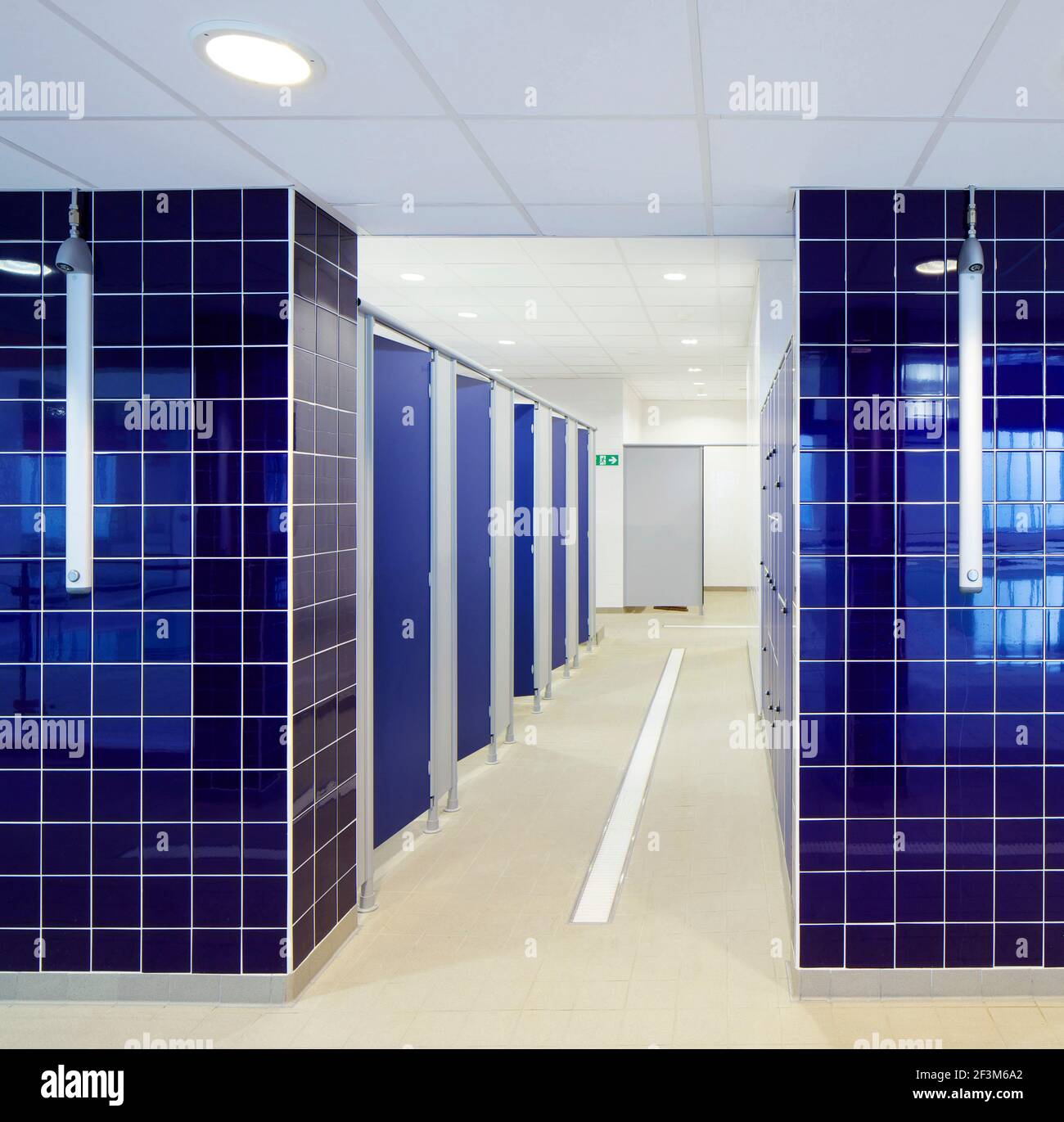 Blue tiled changing room in leisure centre by Wates Construction for ...