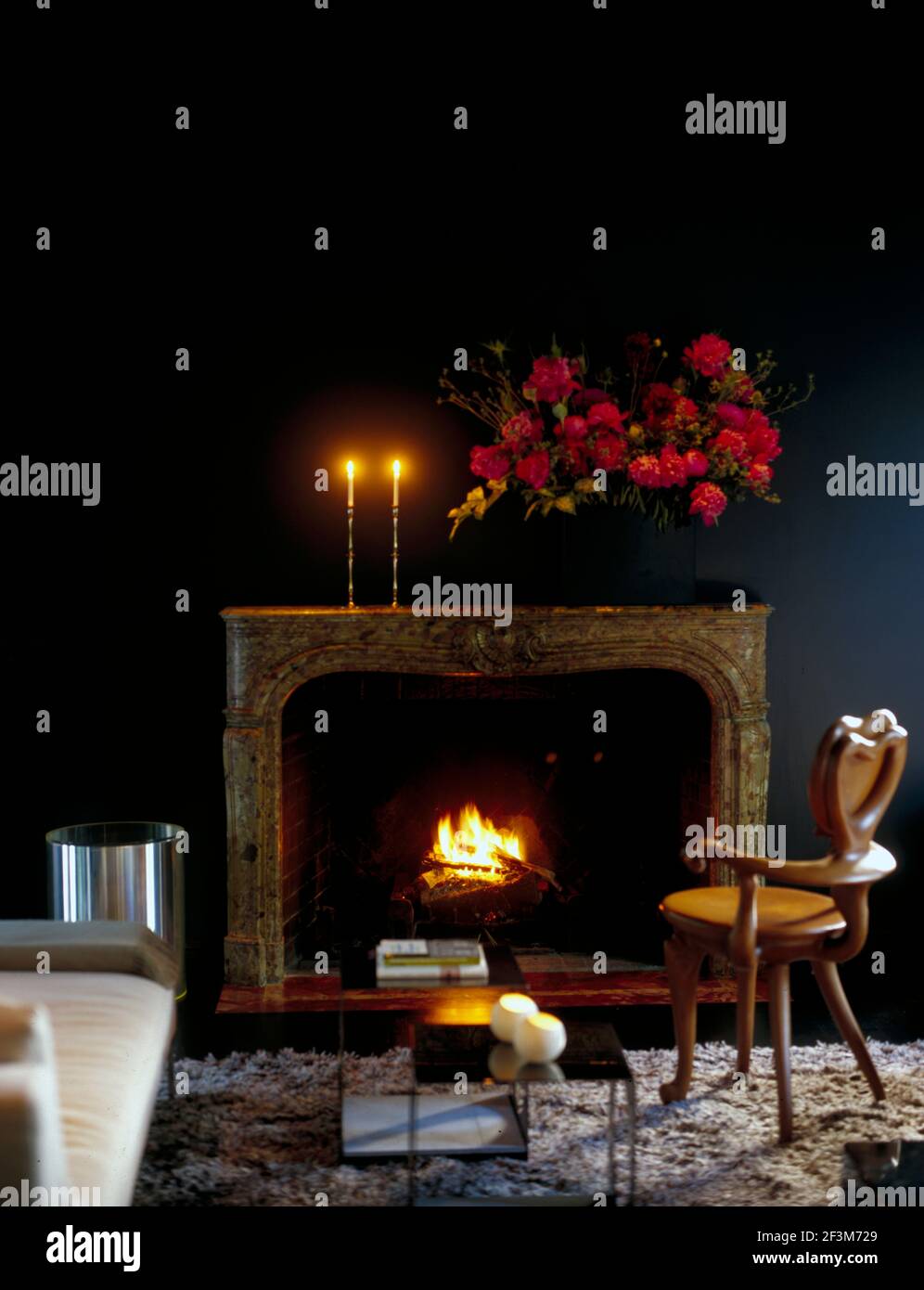 Chair beside lit fire, in Turin home, Italy Stock Photo - Alamy