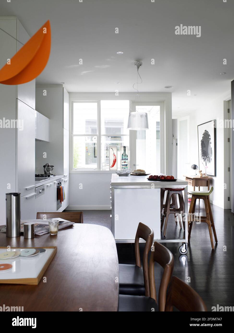 Open plan dining area and kitchen in residential home, Australia Stock ...
