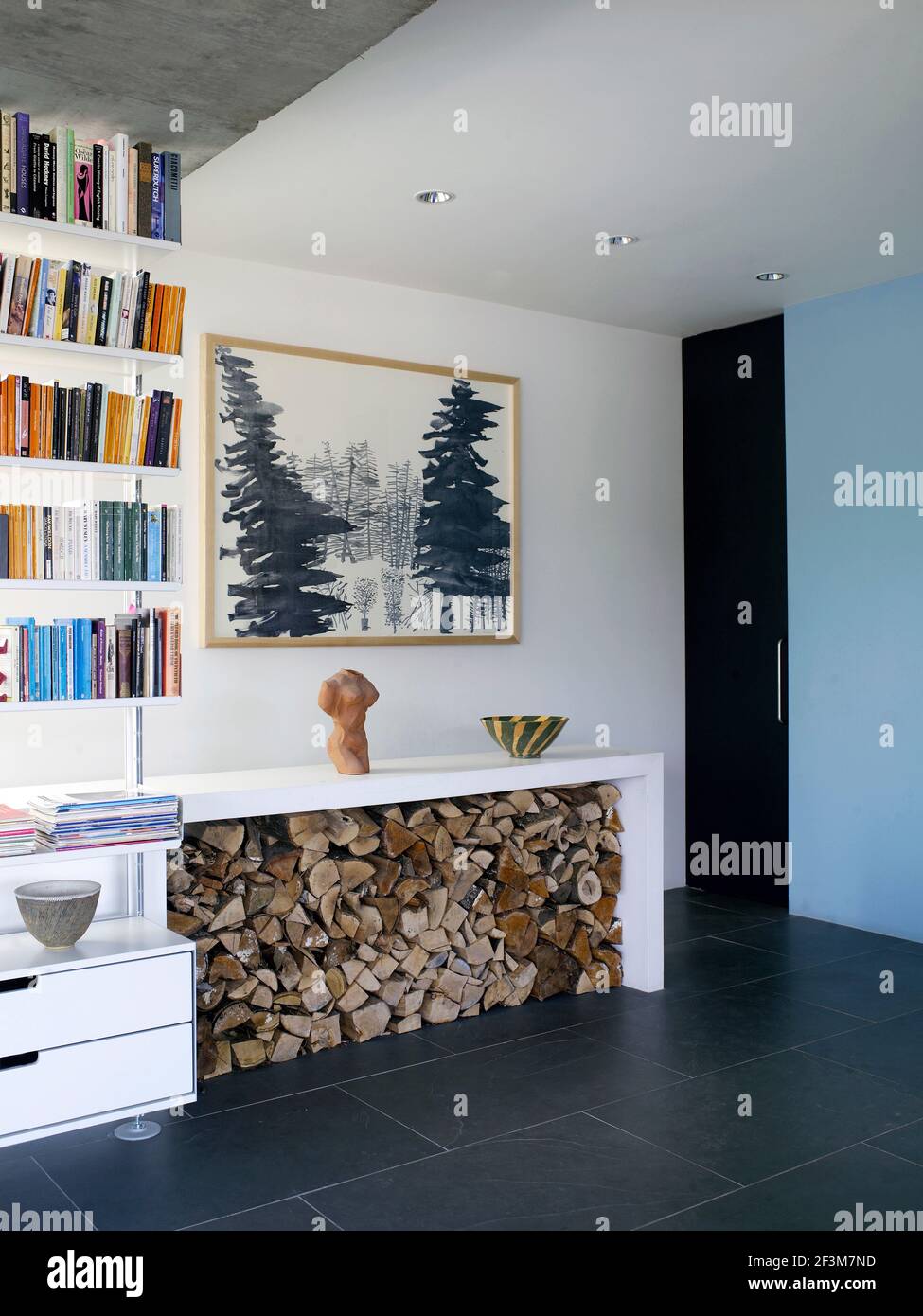Firewood stored under shelf in large open plan room in Batemans Row ...