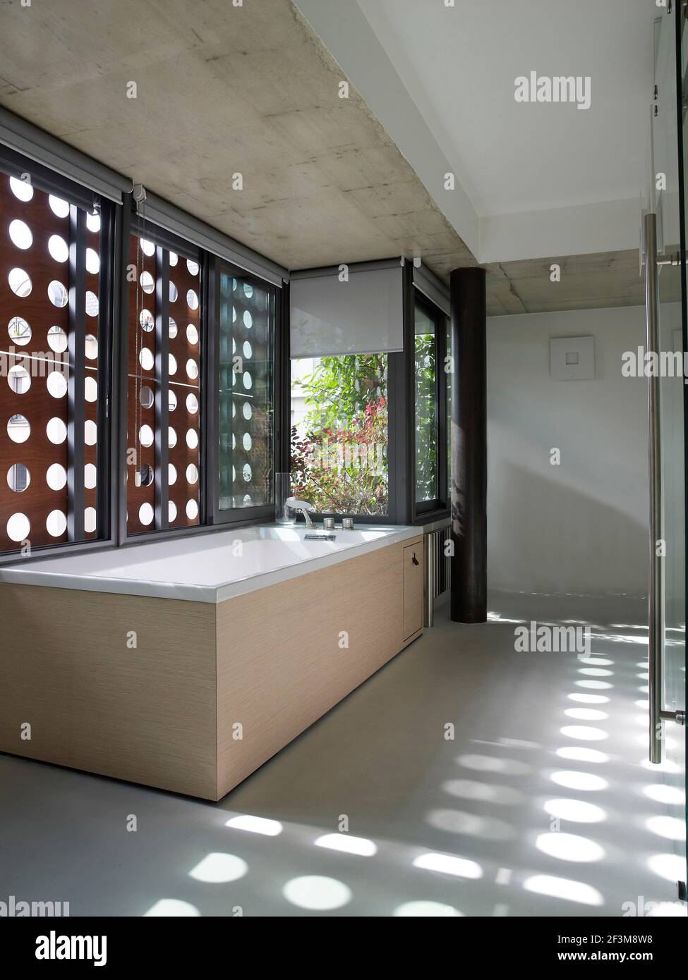 Bathroom with bath under windows in French residential home Stock Photo ...