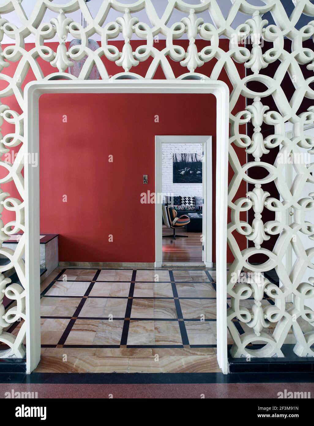 View through ornate wall screen and entrance to Brazilian residential ...