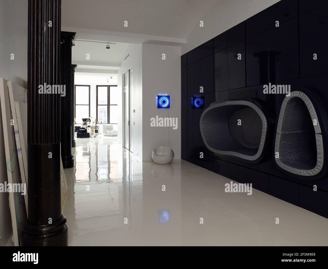 Contemporary hallway with built-in recessed seating in black tiled wall ...