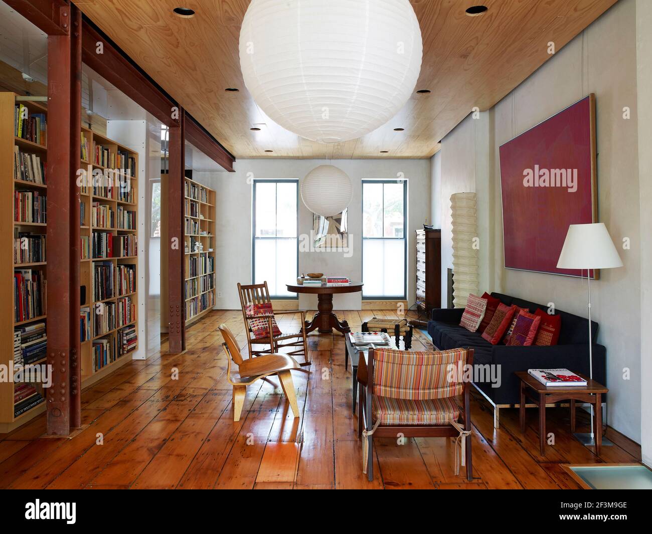 Living room with bookcases, full length windows and seating area in ...