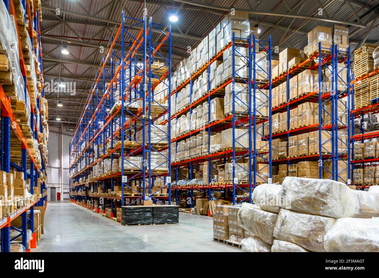 Interior of a modern warehouse storage of retail shop with pallet truck ...