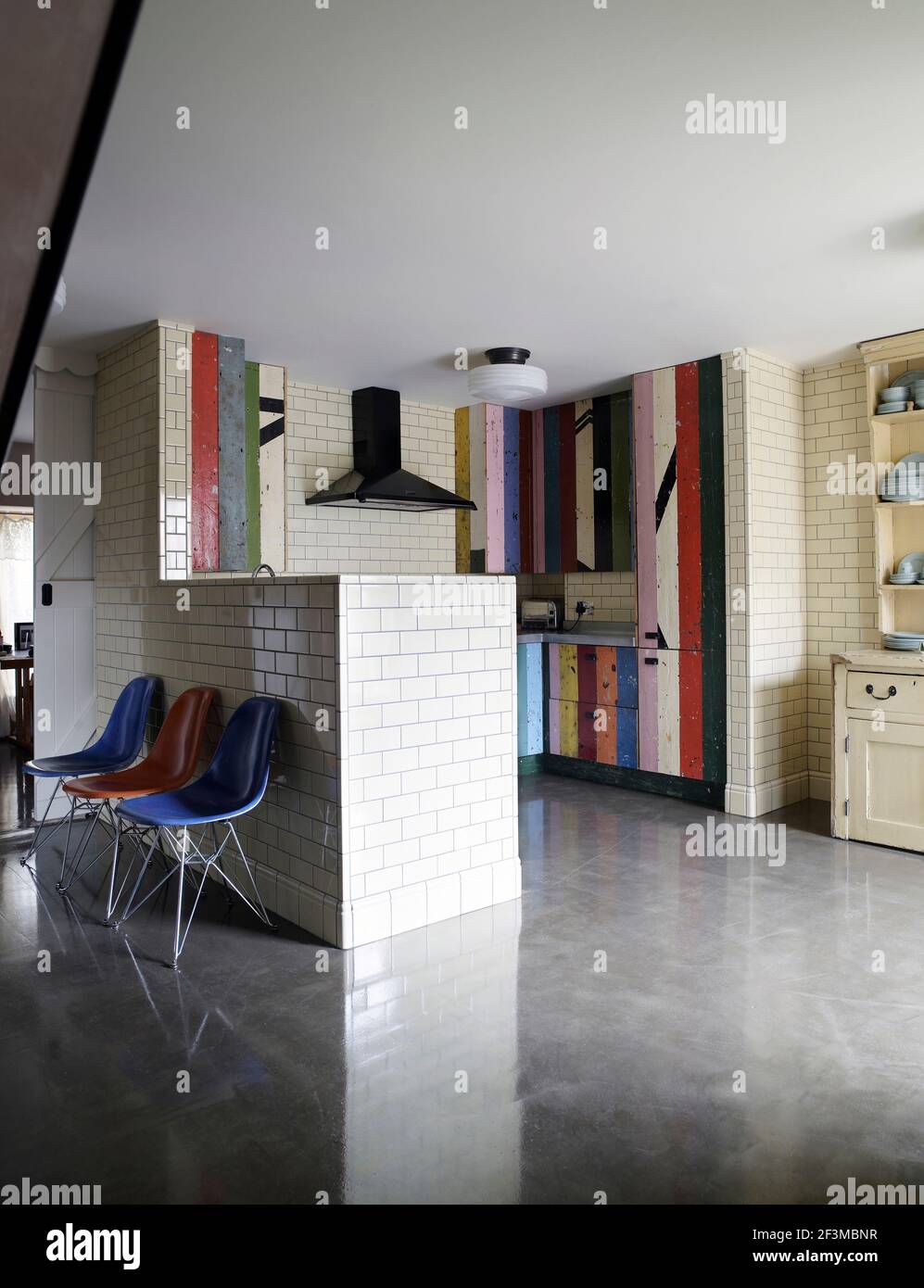 Open plan kitchen and dining area with brick tiles walls, coloured ...