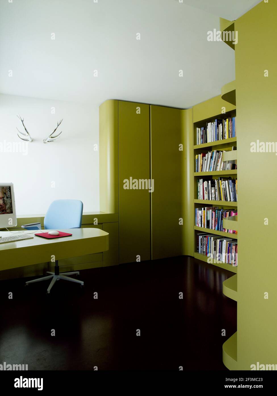 Green study with desk and bookcase in residential house, Switzerland ...