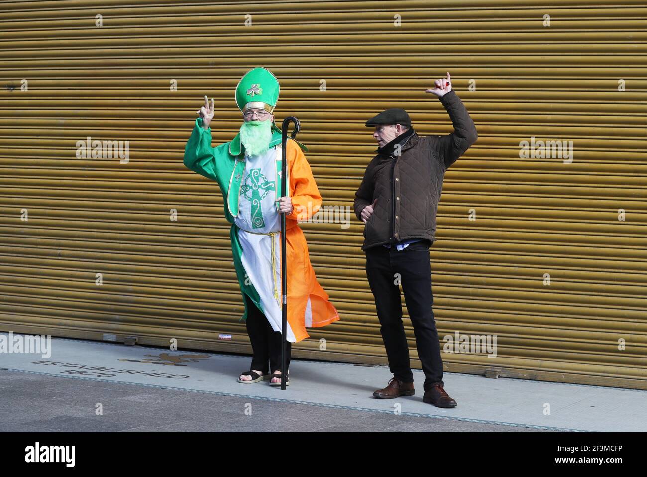Members of the public interact with a man dressed as St Patrick on O ...