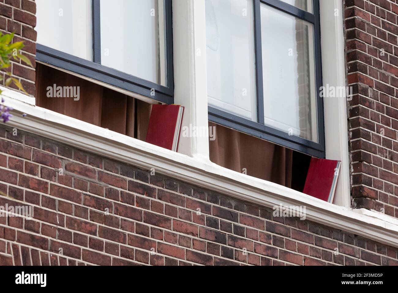Second use of old books to keep the window open close up Stock Photo ...
