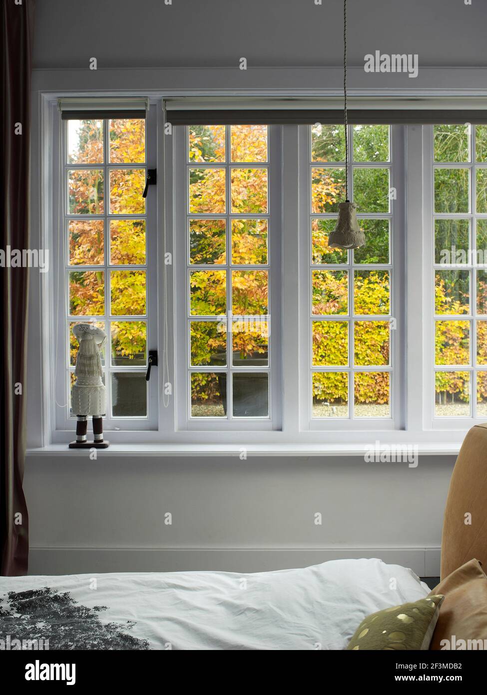 View through bedroom window to autumnal scene with ornament on ...
