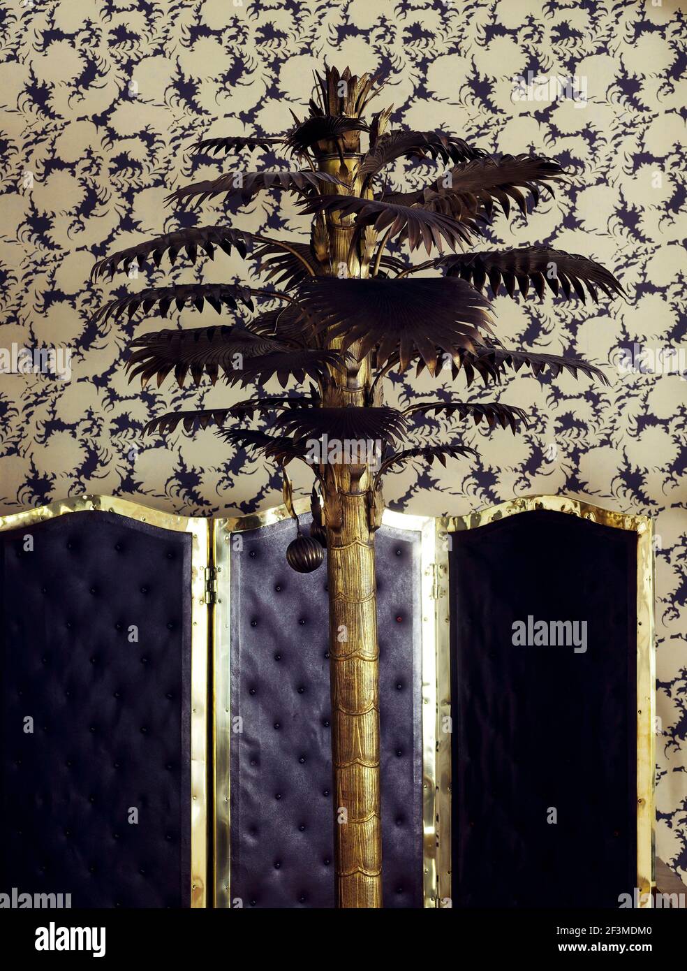 Rich patterned wallpaper with padded modesty screen with gold palm ...