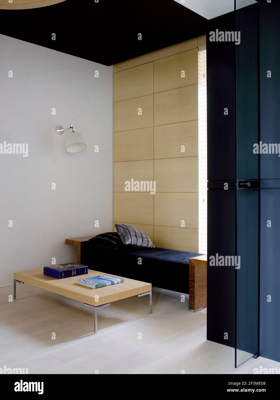 Patterned feature wall with bench seating and coffee table Stock Photo ...