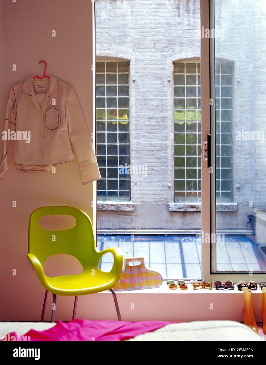 Green chair at open sliding door in modern apartment, USA Stock Photo ...