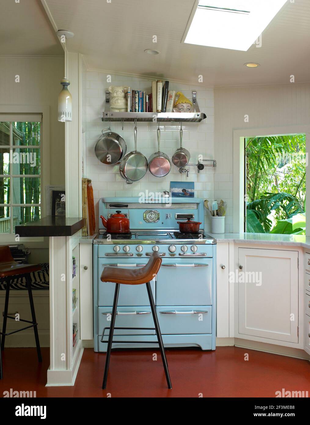 Kitchen with blue oven, breakfast bar and stools in residential house ...