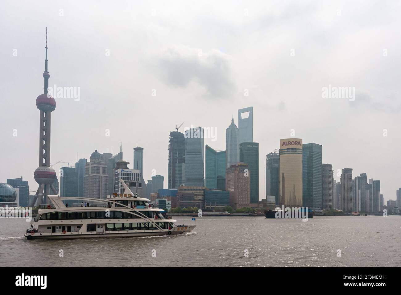 Shanghai, China - May 4, 2010: Passenger ferry on river in front of ...