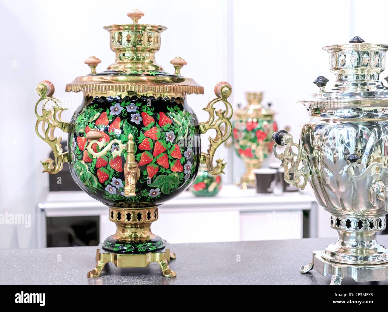 Russian samovar with a strawberry pattern in the Khokhloma style Stock ...