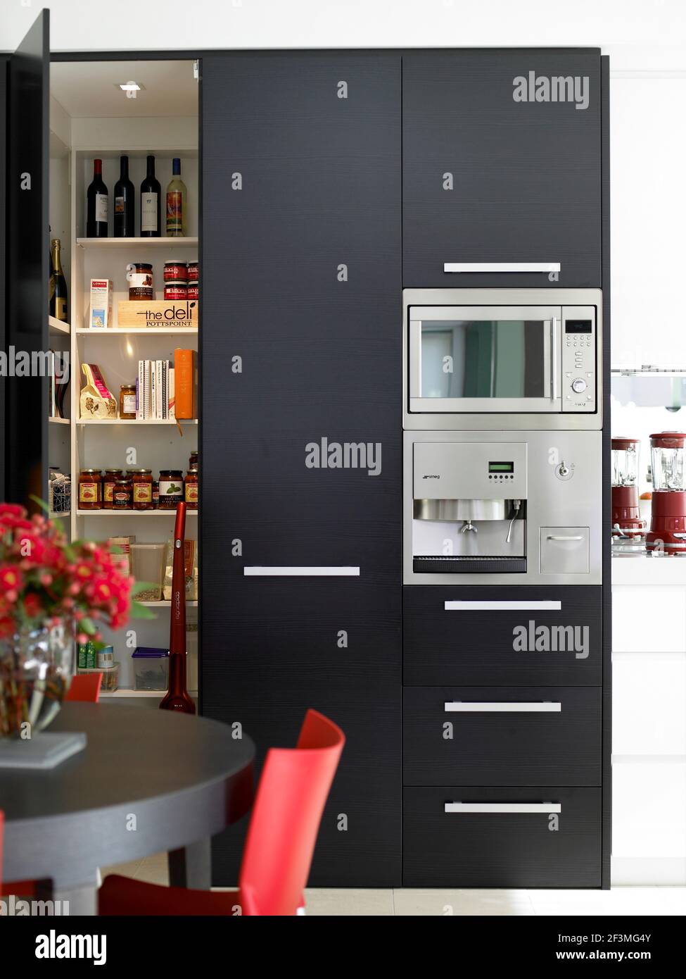 Storage cupboard and integral oven in kitchen of residential home ...