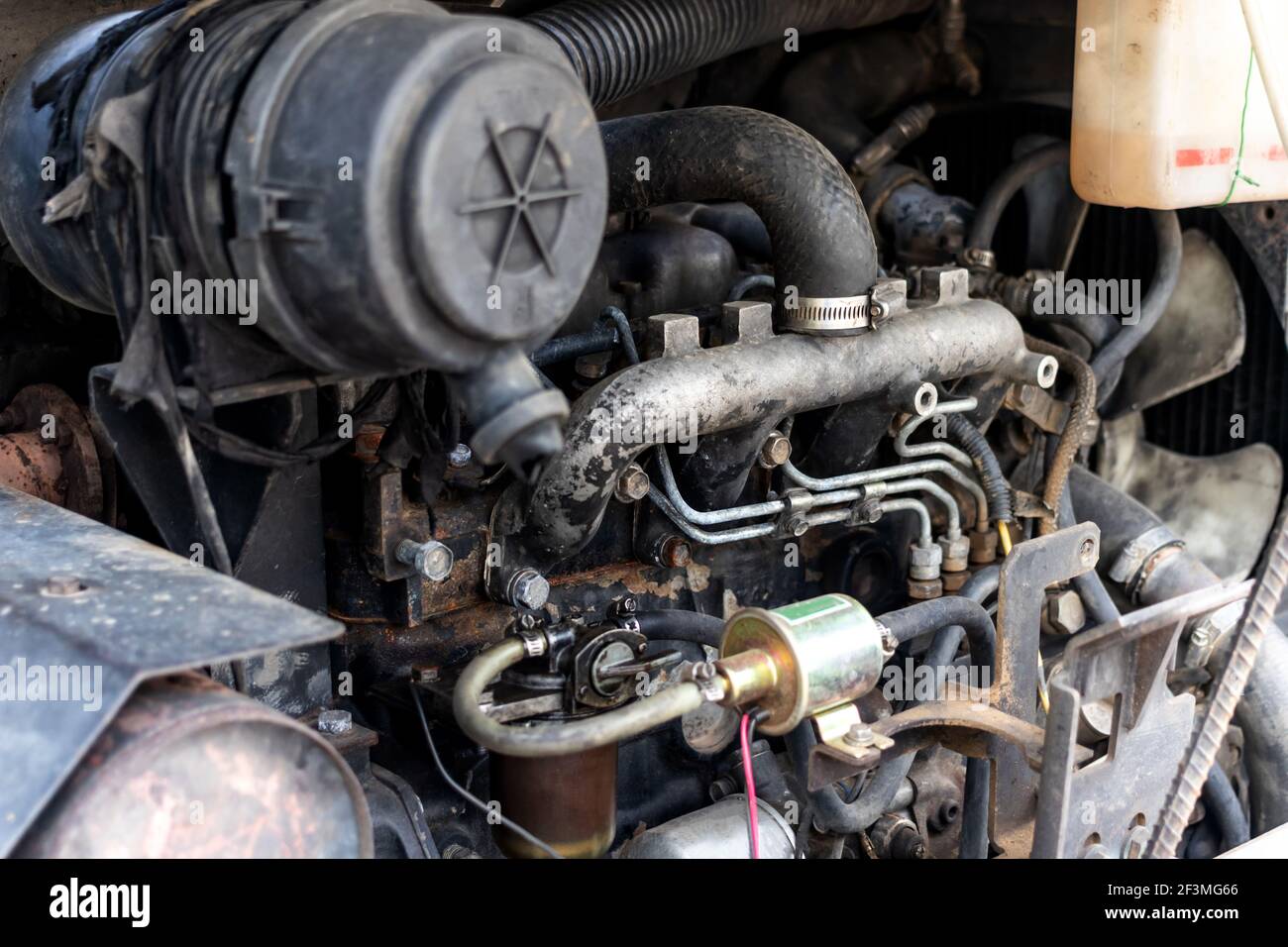 Close up pipes and old Loader car diesel engine. Car old engine part ...
