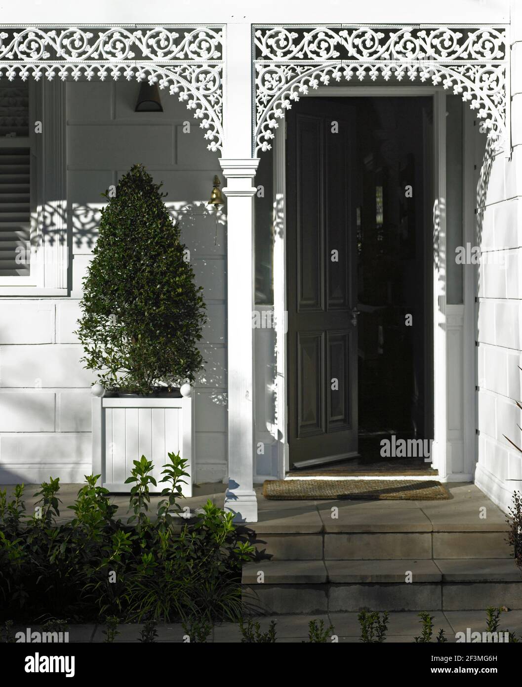 Ornate carved porch detail with view into Australian home Stock Photo ...