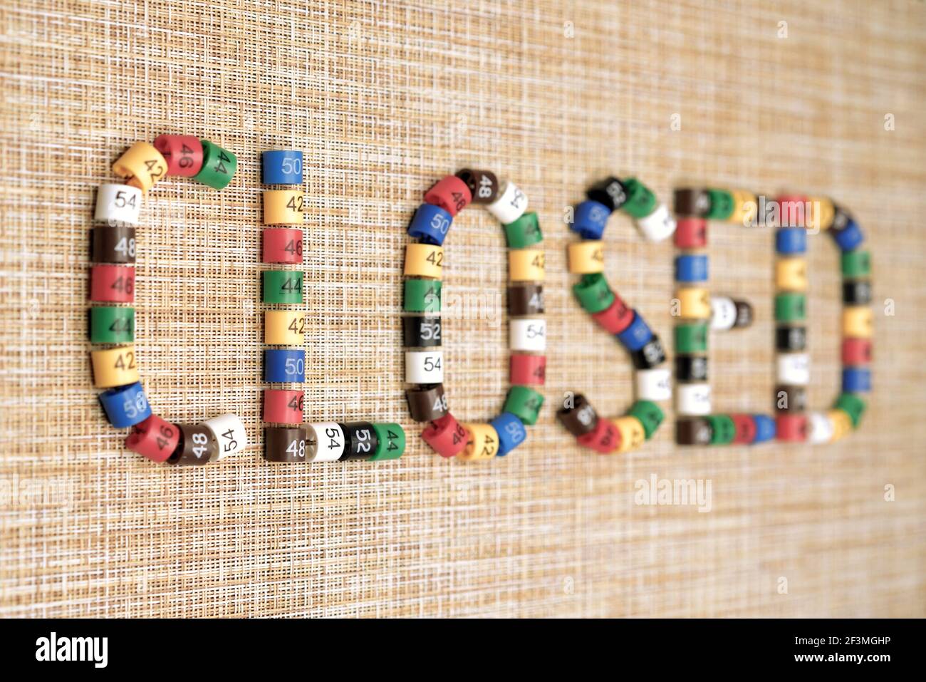 CLOSED inscription made of many multicolored plastic size labels ...