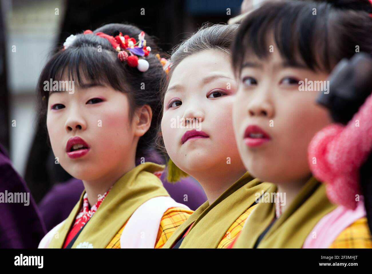 Three young Japanese females (one in focus, two out of focus - shot at ...