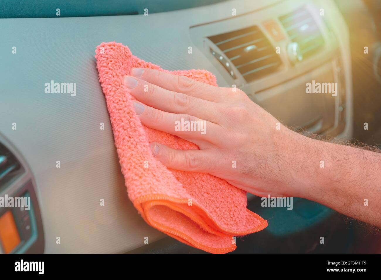 Hand with cloth cleaning car interior Stock Photo - Alamy