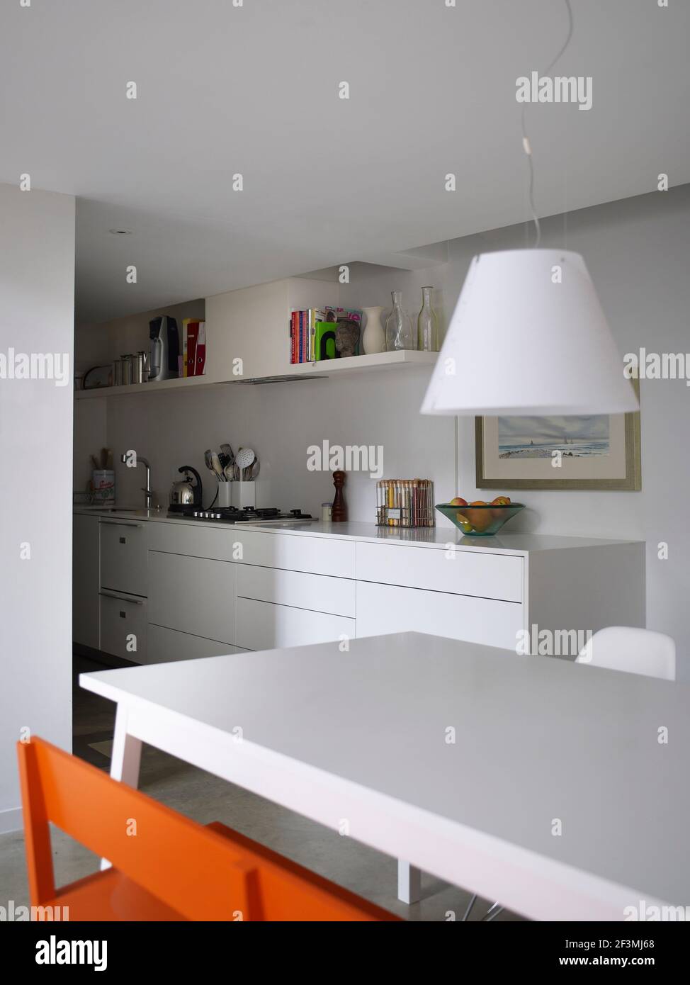 Pendant light above table in kitchen of UK home Stock Photo - Alamy