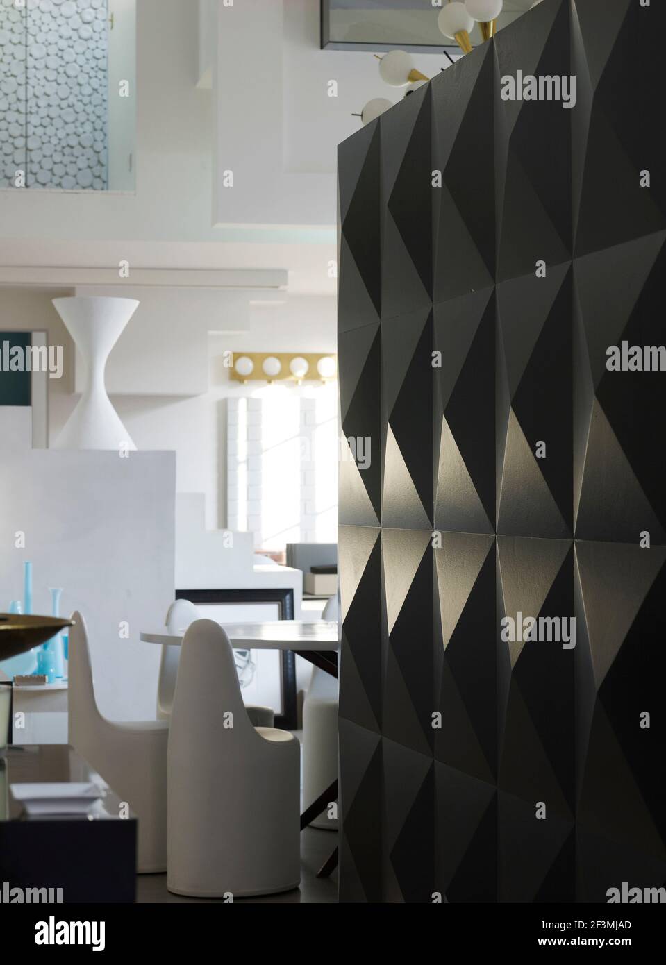 View past wall partition to dining room area in French home Stock Photo ...