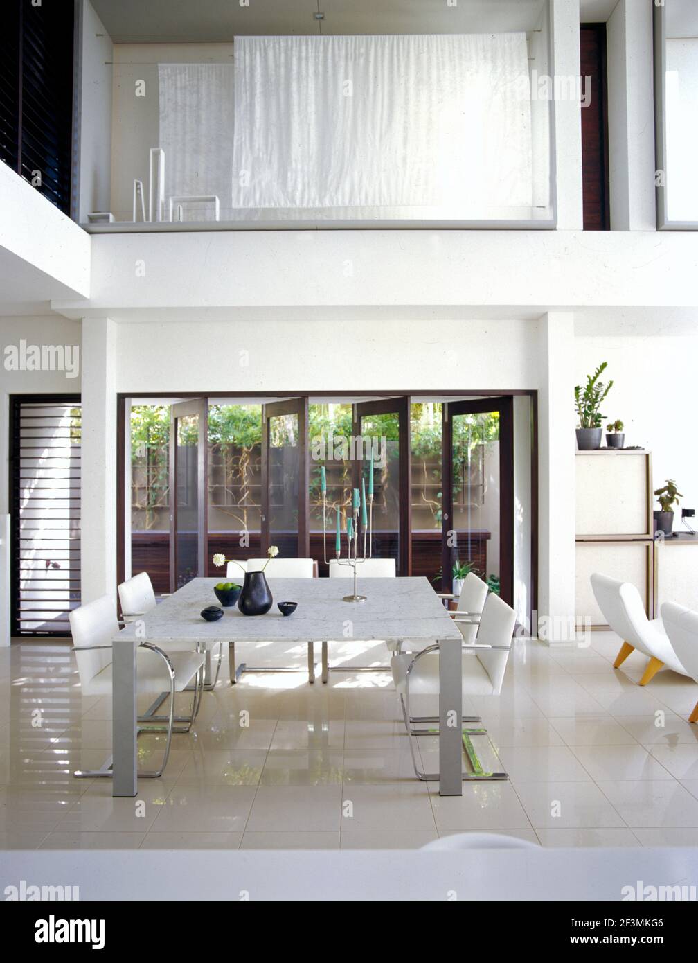 Table and chairs in spacious open plan dining room, Australia Stock ...