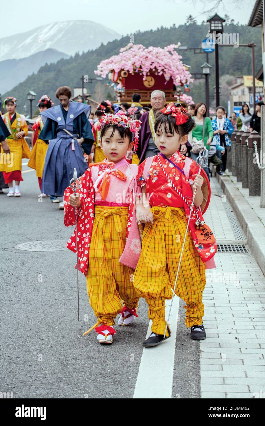 Two cute young Japanese girls lead the procession of floats (hanayatais ...