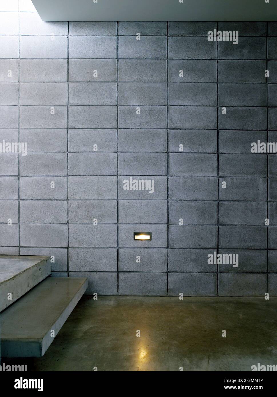 Stone wall with inset light in New Zealand home Stock Photo - Alamy